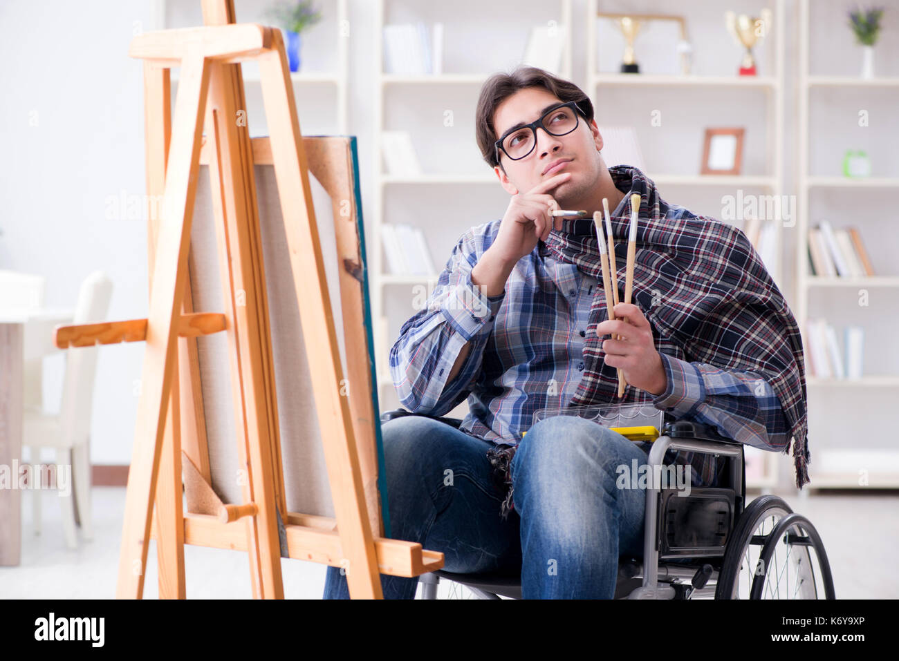 Disabled artist painting picture in studio Stock Photo - Alamy