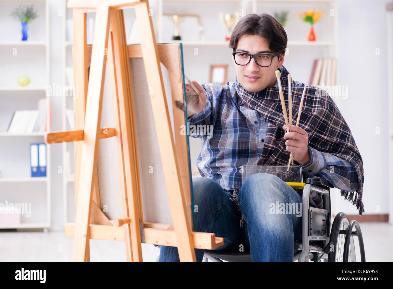 Disabled artist painting picture in studio Stock Photo - Alamy