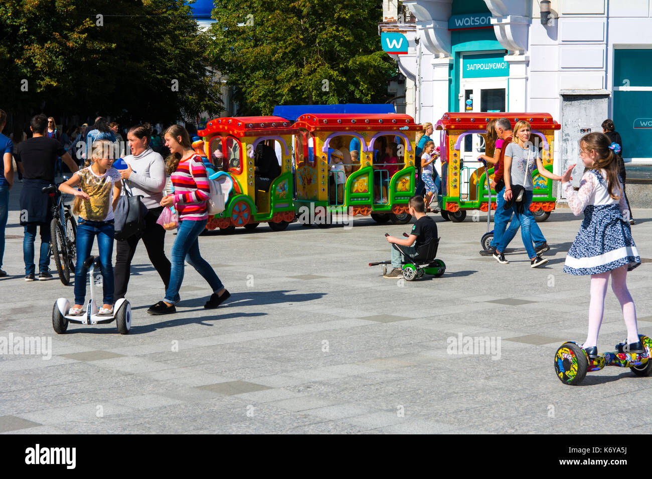 A small tram on the square rolls the children. Day of the city ...