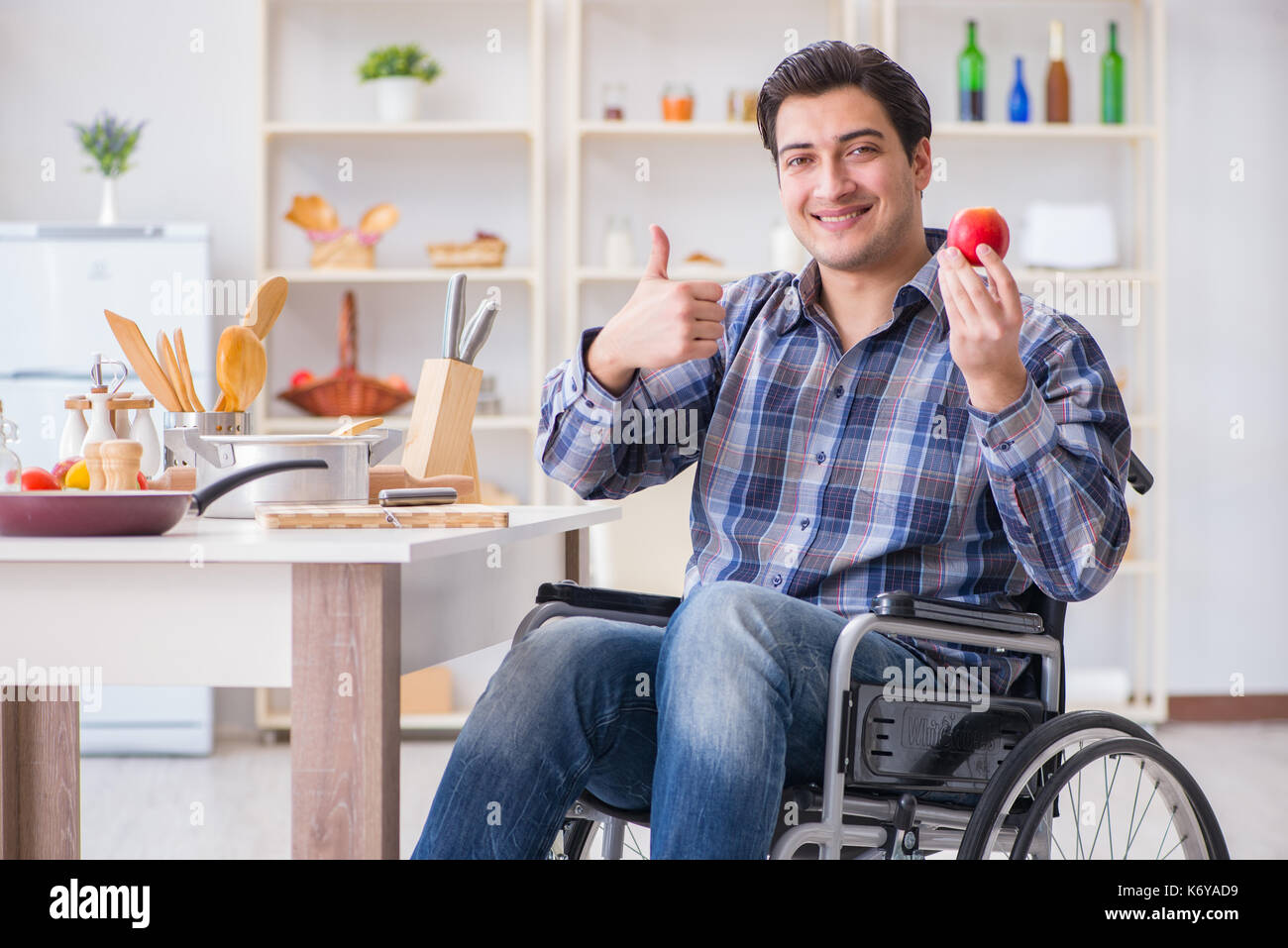 Young disabled husband preparing food salad Stock Photo - Alamy