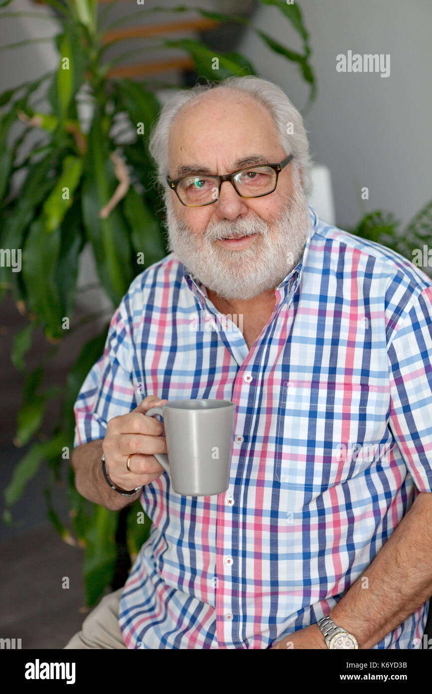 Senior bearded man drinking coffee at home Stock Photo - Alamy