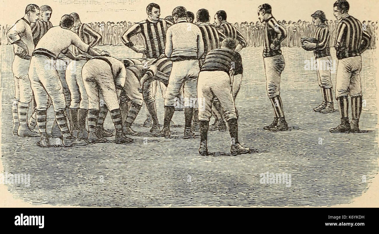 This image captures the formation of a scrum in early *rugby union*, a ...
