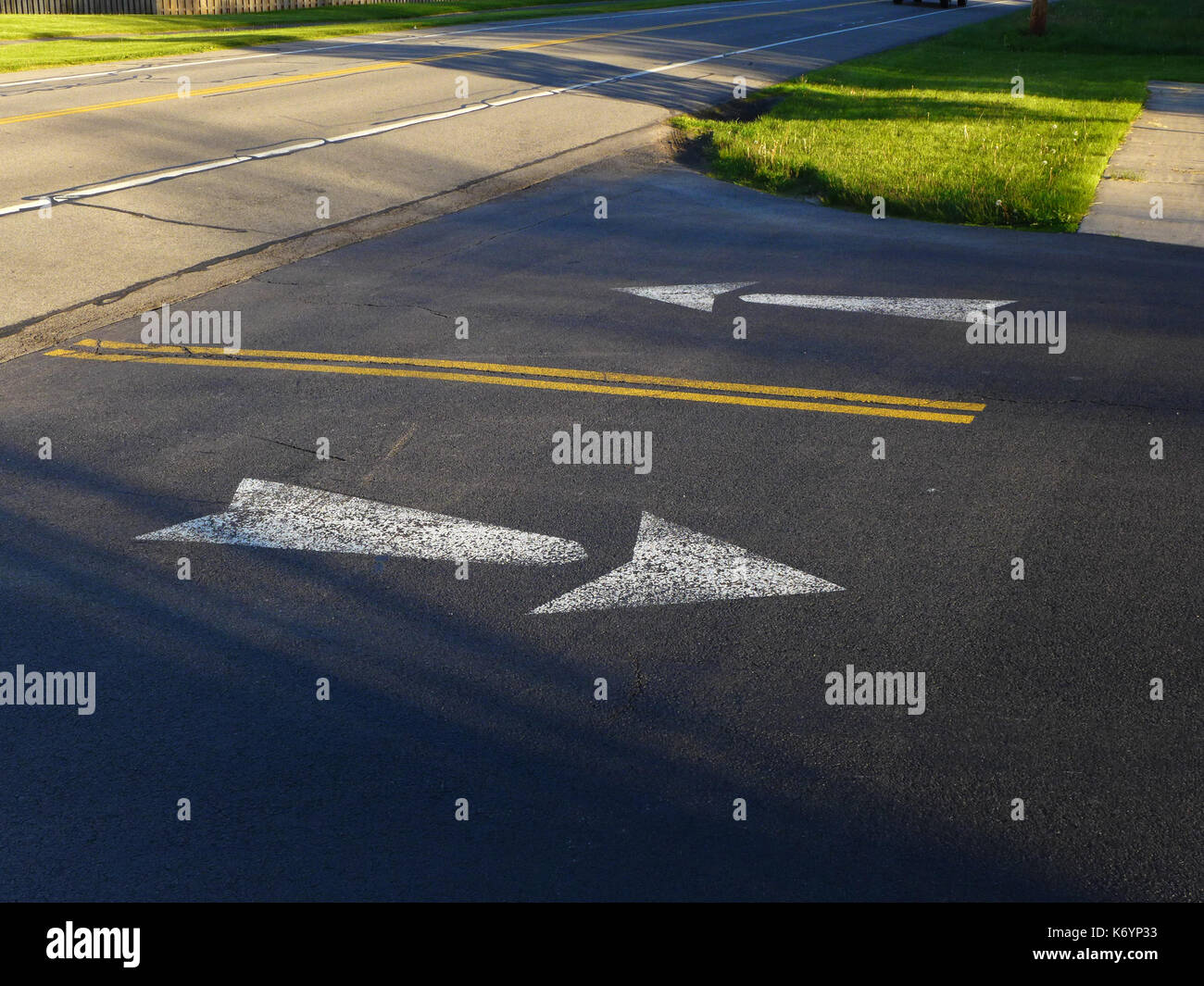 In and out arrows ob pavement Stock Photo - Alamy