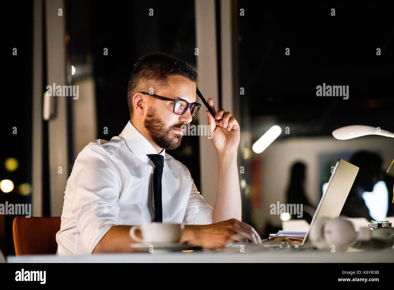 Businessman in the office at night working late Stock Photo - Alamy