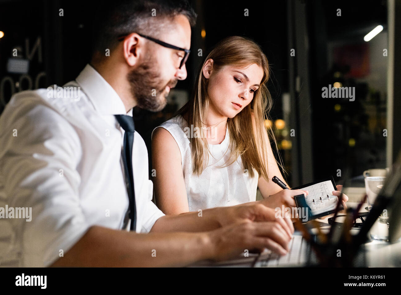 Businesspeople in the office at night working late Stock Photo - Alamy