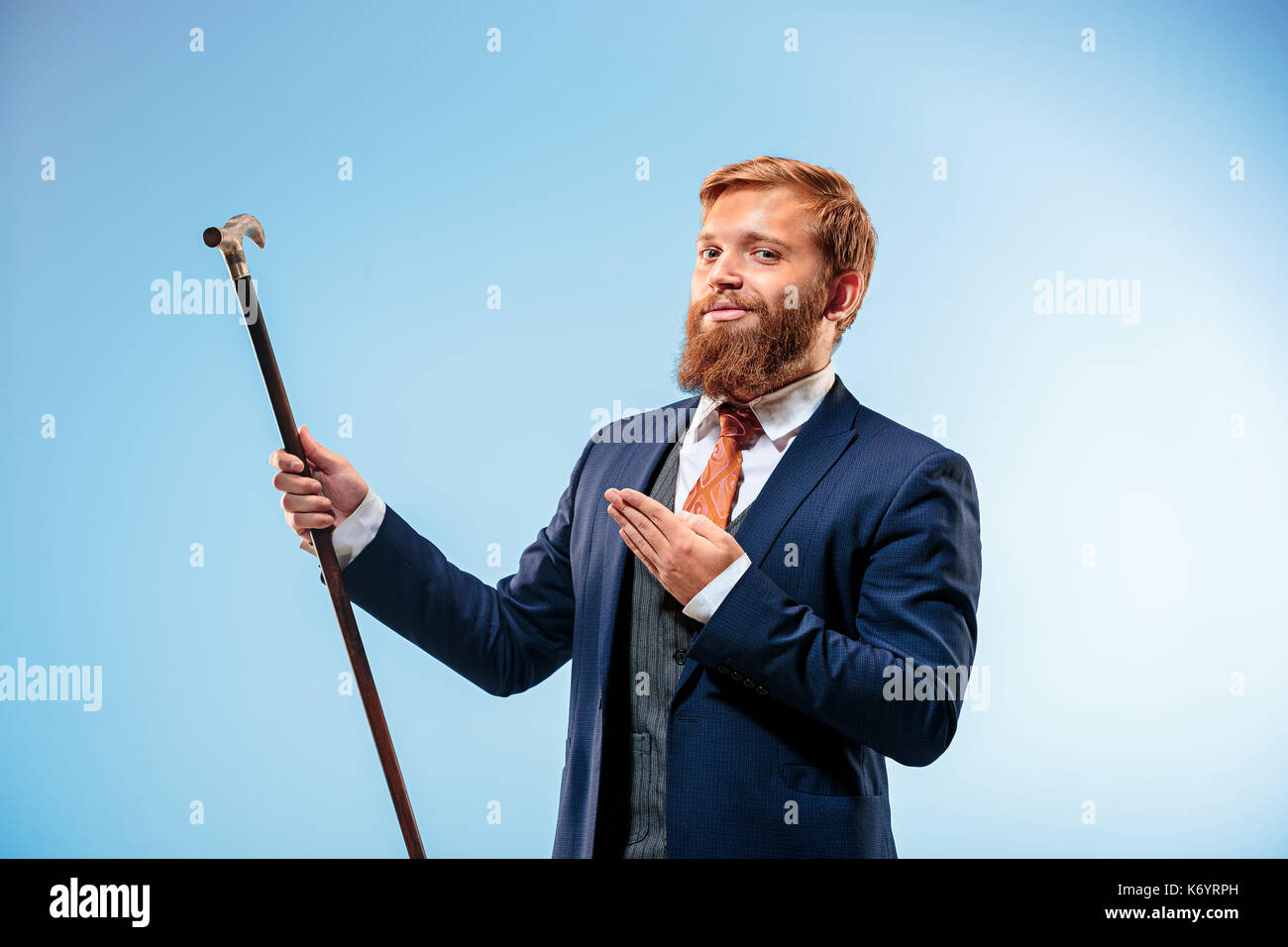 Tattooed bearded man in a suit holding cane Stock Photo - Alamy