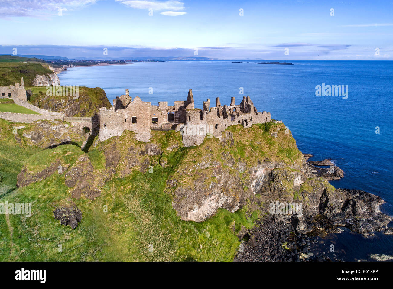 Ruins of medieval Dunluce Castle, cliffs, bays and peninsulas. Northern ...
