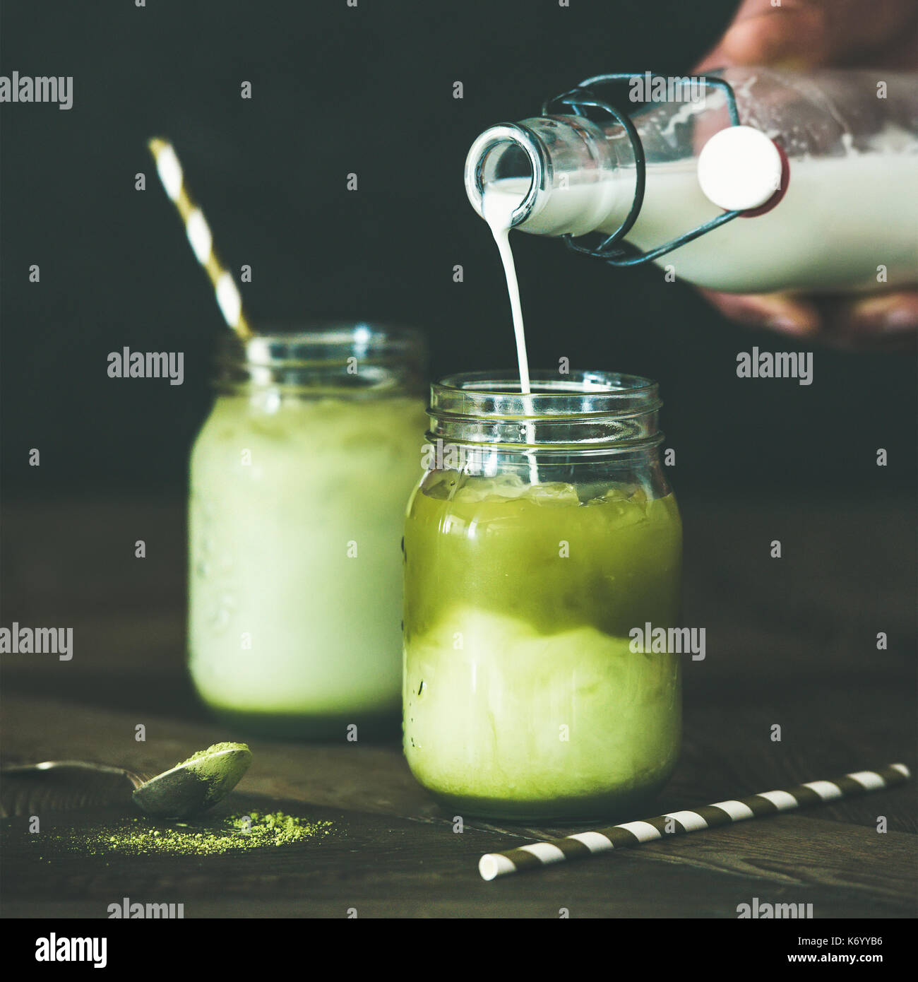 Cold refreshing iced coconut matcha latte drink, dark background Stock ...
