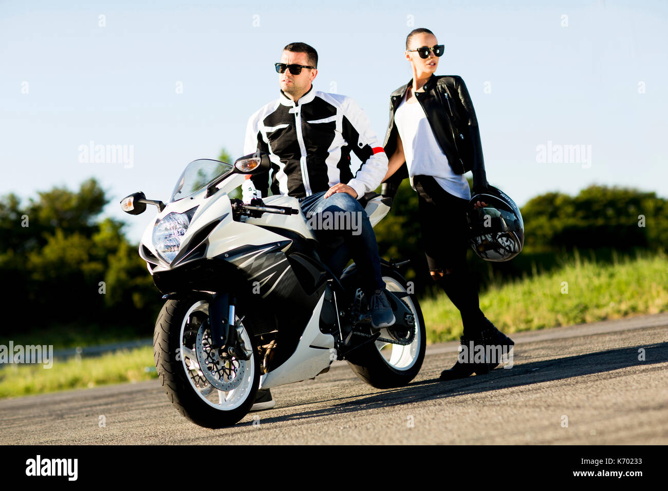 Young man and a woman on a motorcycle by day Stock Photo - Alamy