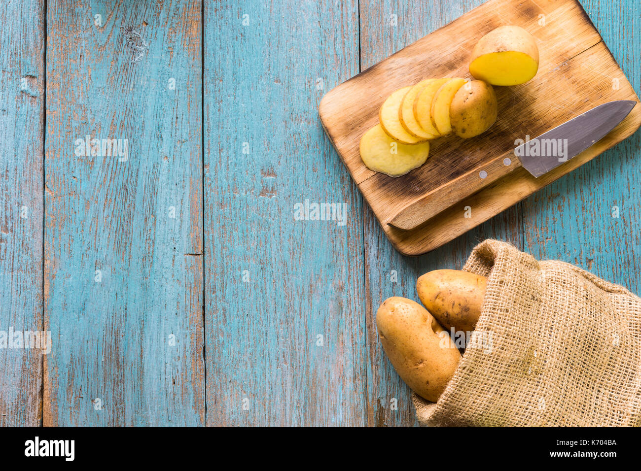 Pile of potatoes lying on wooden boards with a potato bag in the ...