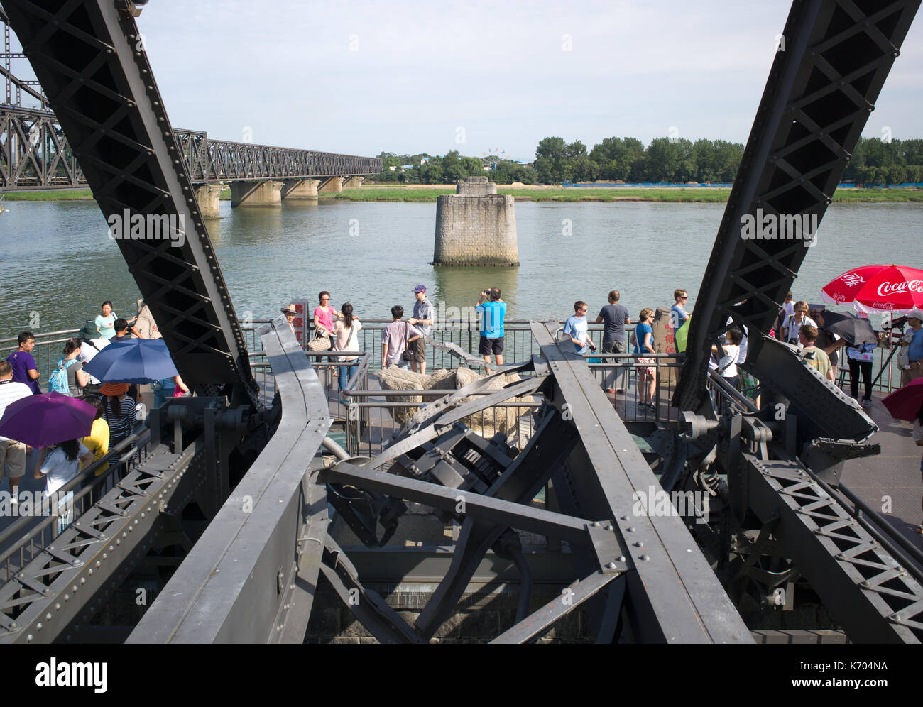 Tourists at bombed end of Broken Bridge across Yalu River, looking ...