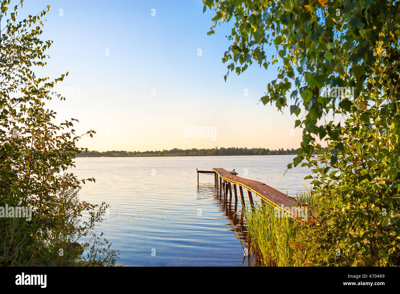 rural summer landscape with river bridge. pier on lake Stock Photo - Alamy