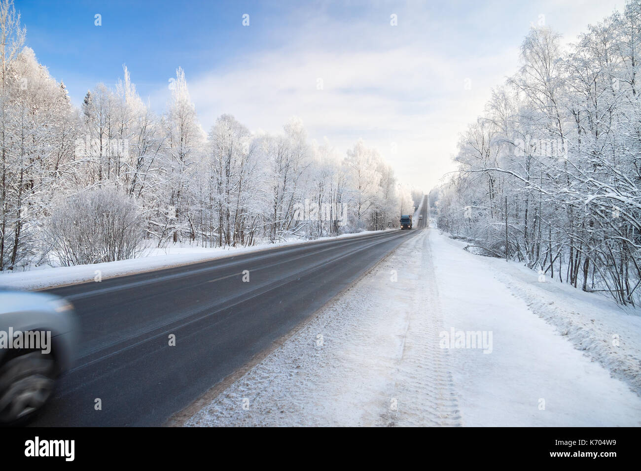 beautiful winter landscape with asphalt road,forest and blue sky ...