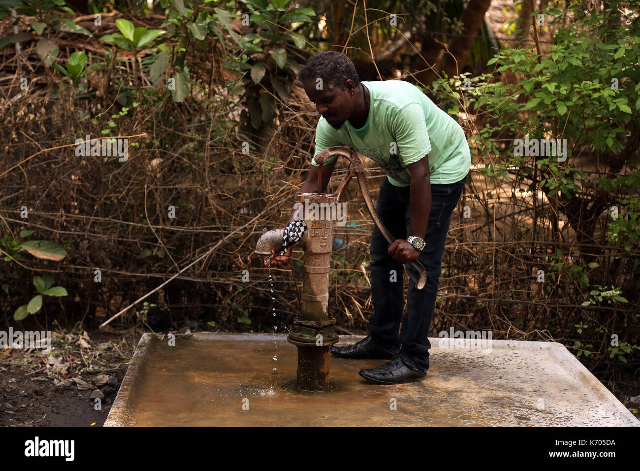 Indian boy splashing water on hi-res stock photography and images - Alamy