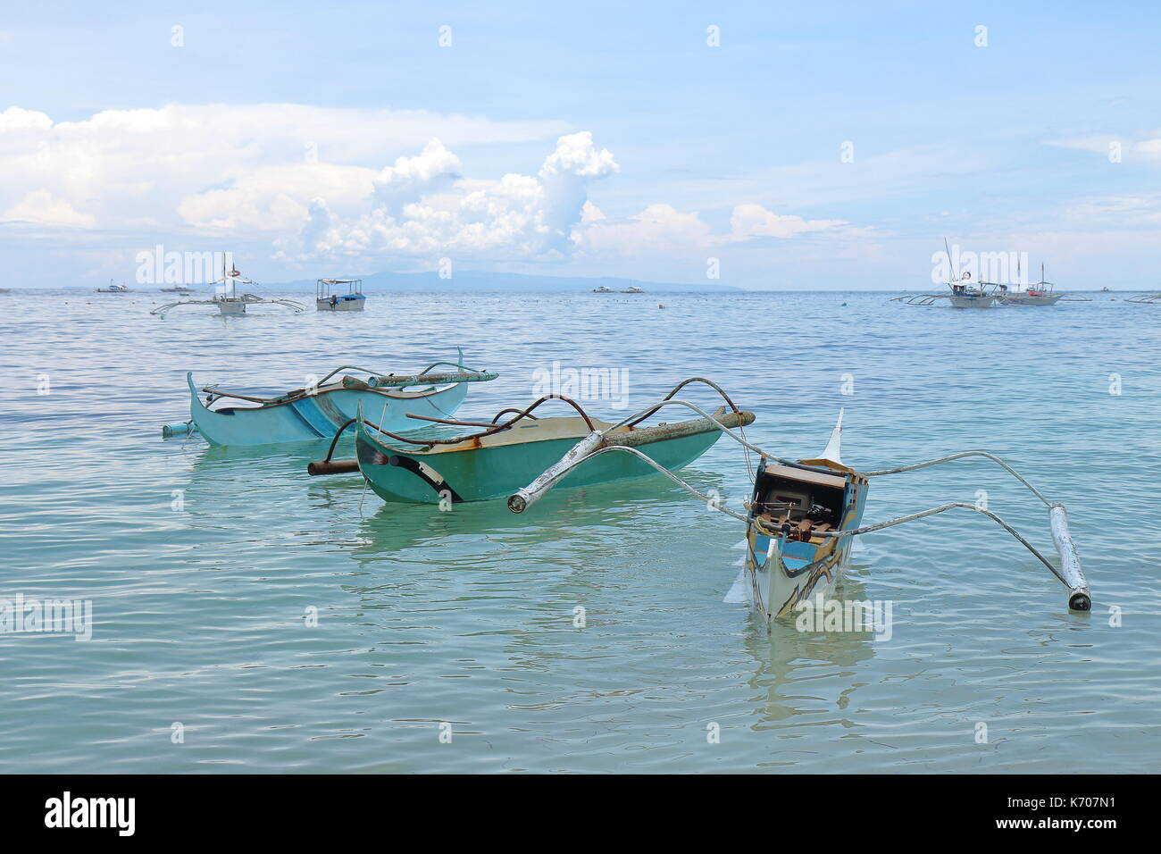 Three paddle-driven boats floating close to the shore. Photo taken in a ...