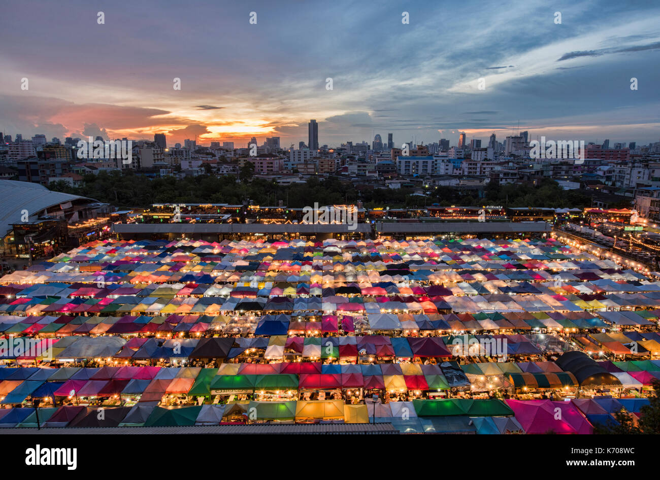The colorful Ratchada Rot Fai Train Market at sunset, Bangkok, Thailand ...