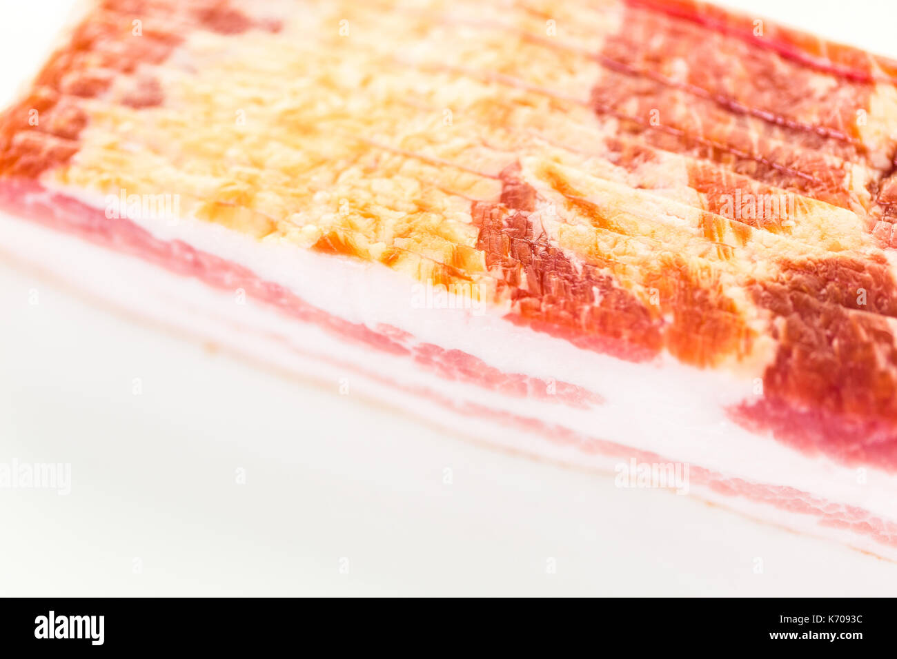 Uncooked bacon strips on a white background Stock Photo - Alamy