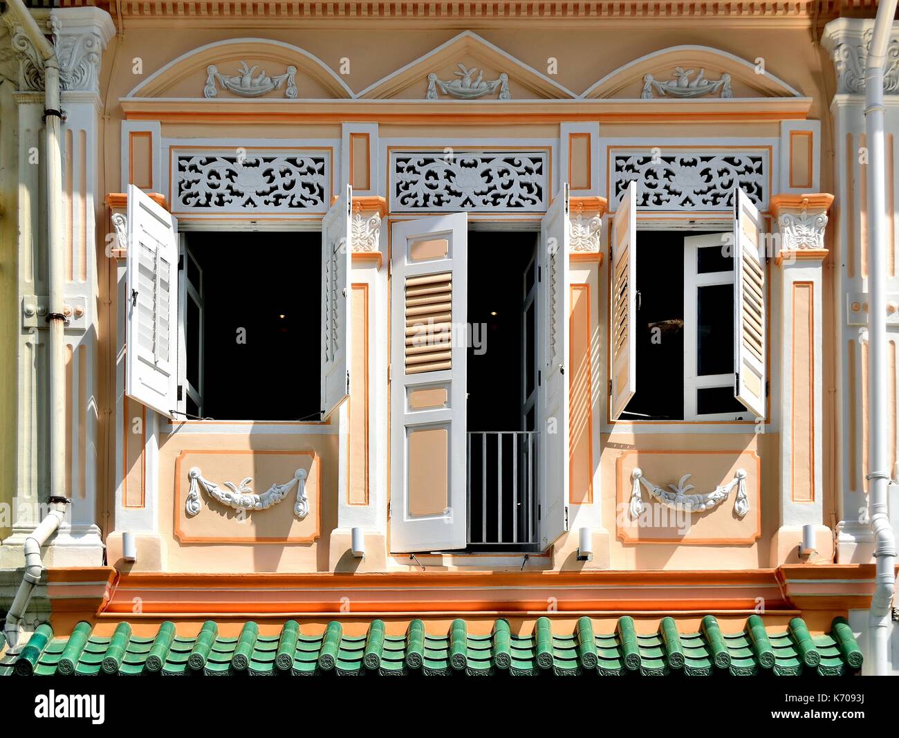 Traditional shop house exterior with orange and white facade, orange ...