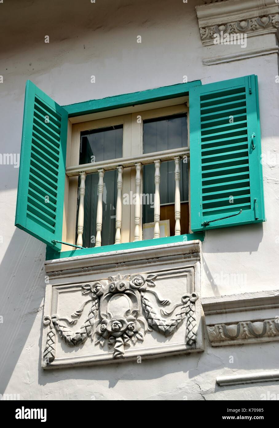 Traditional shop house exterior with white facade, window, green wooden ...
