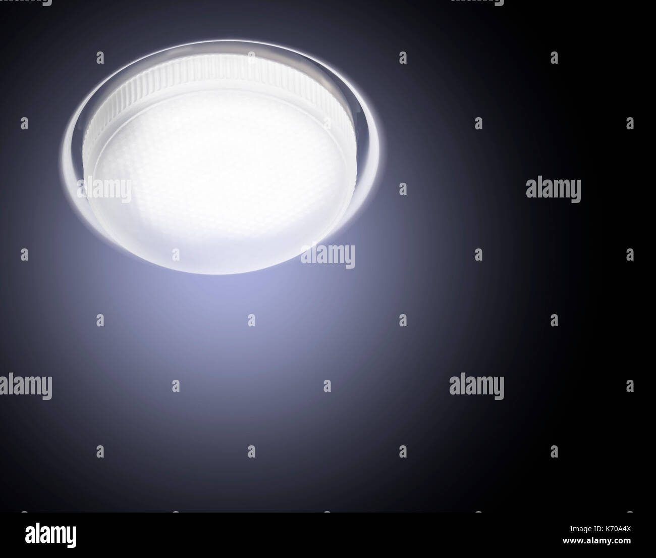 Ceiling Recessed LED lamp is lit close-up cold light on a black ...