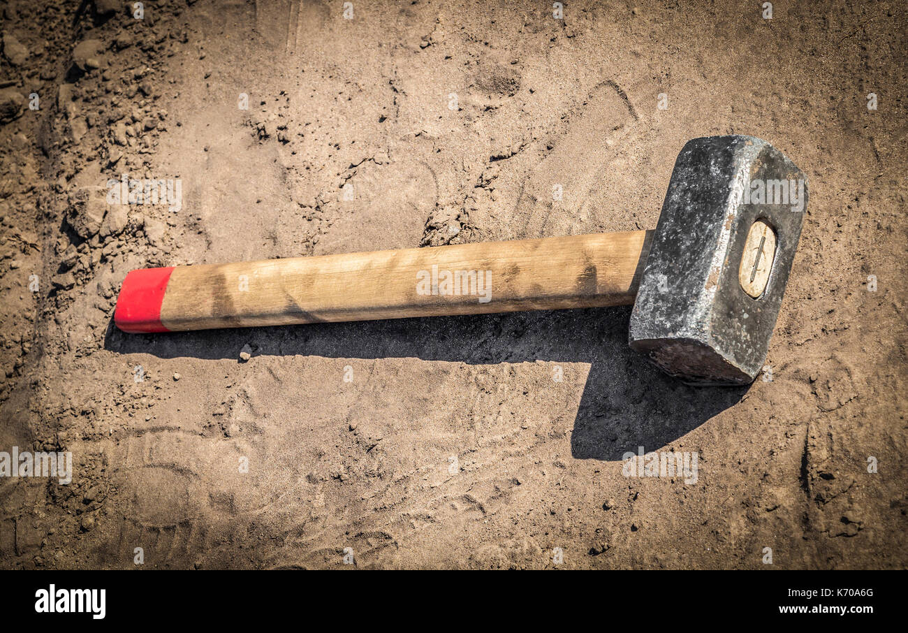 Hammer on the sand during rest closeup Stock Photo - Alamy