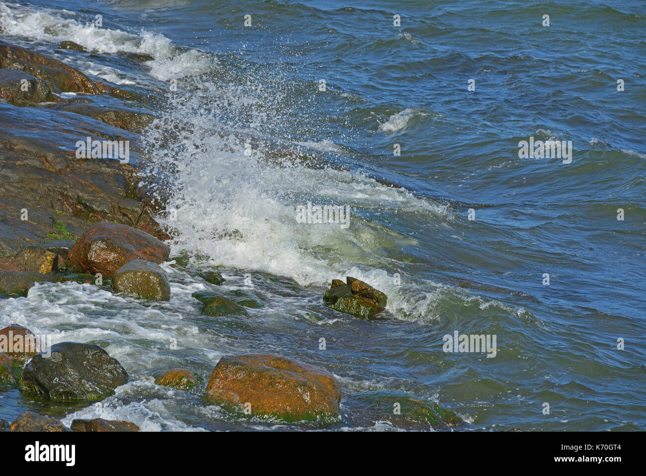 Rocky seashore with waves Stock Photo - Alamy