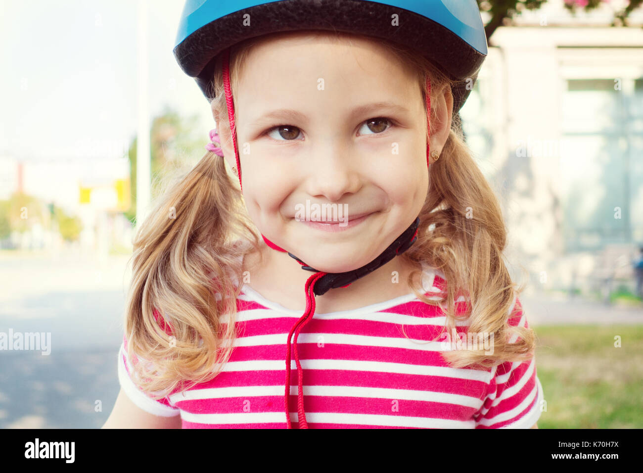 Pretty little child girl ride and having fun with bicycle in summer ...