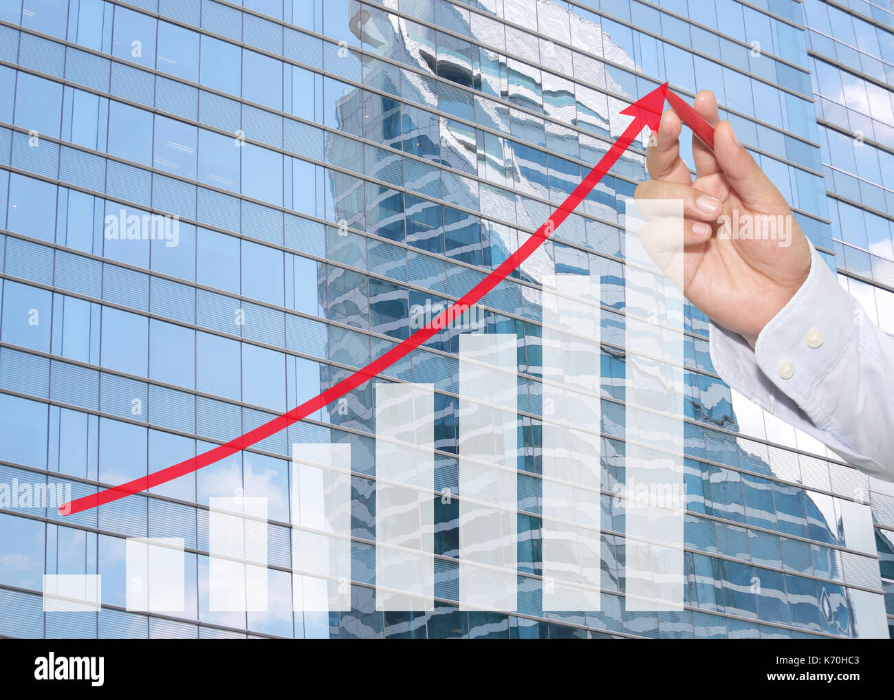 hand of businessman using red pen pointing to top business graph on ...