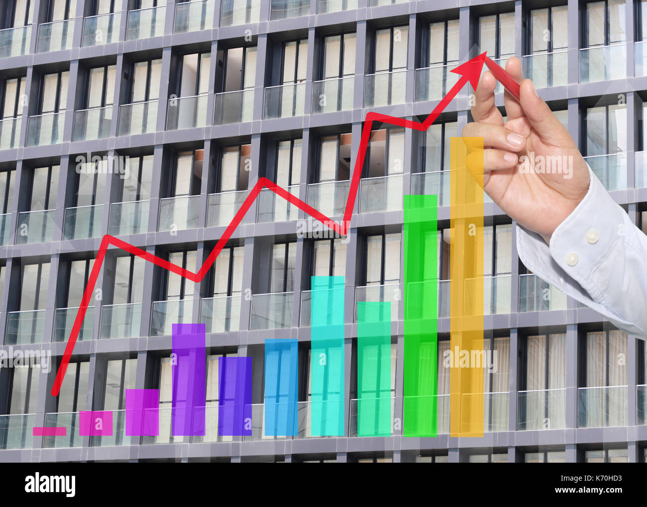 hand of businessman using red pen pointing to top business graph on ...