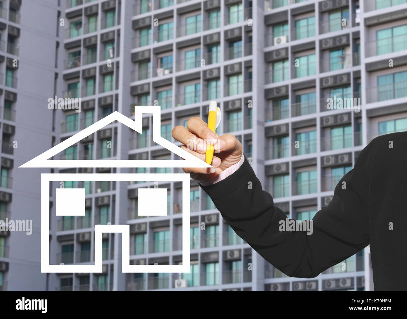 hand of business woman using yellow pen write symbol of house on glass ...