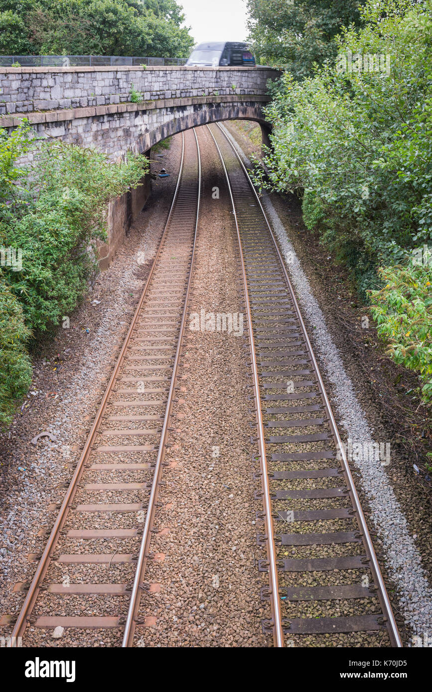 Train lines with brick arch road bridge Stock Photo - Alamy
