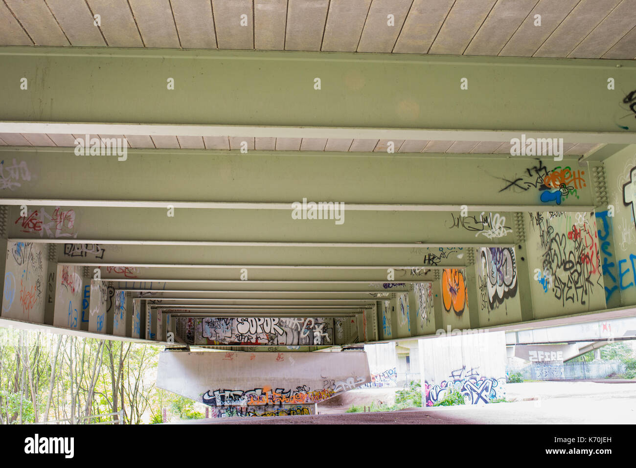Underside of road bridge with graffiti on either side Stock Photo - Alamy