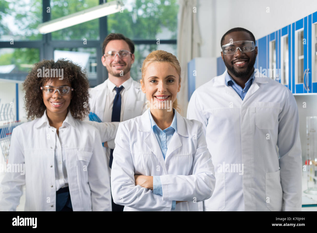 Smiling Group Of Scientists In Modern Laboratory With Female Leader, Mix Race Team Of Scientific ...