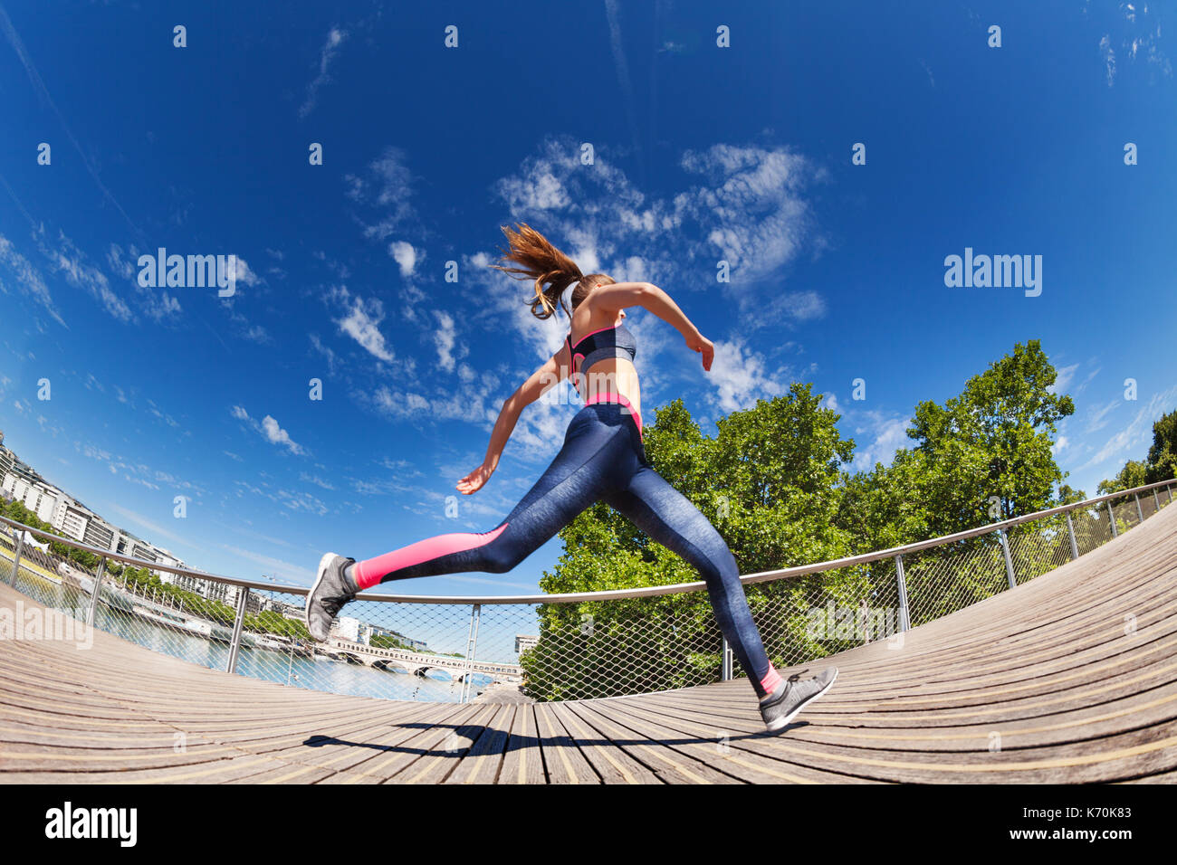 Side view portrait of sportswoman running and sprinting outdoors in ...