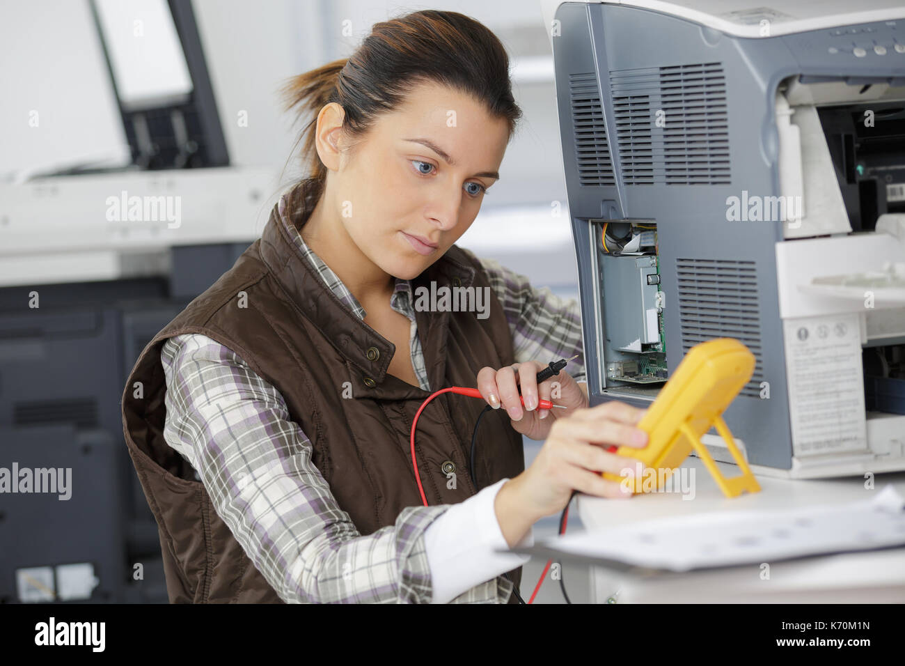 handywoman checking computer with a multimeter Stock Photo - Alamy