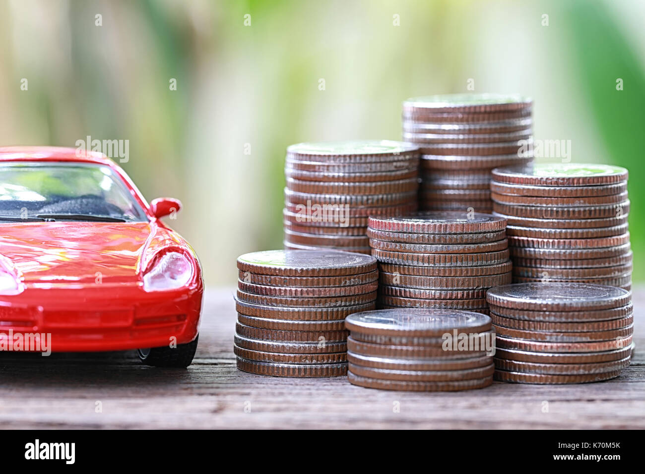 Silver coin of pile with red car model in concept savings to buy a new ...