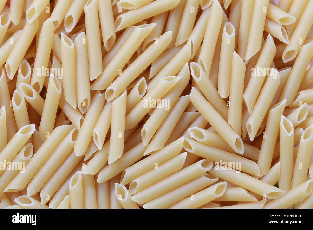 Raw Macaroni background for design food backdrop Stock Photo - Alamy