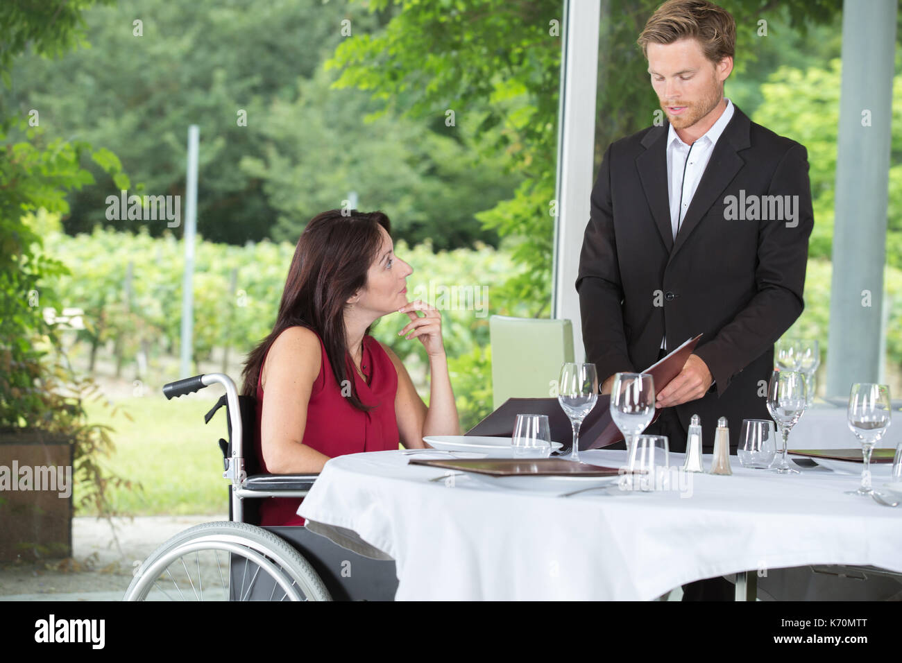 giving the menu Stock Photo - Alamy