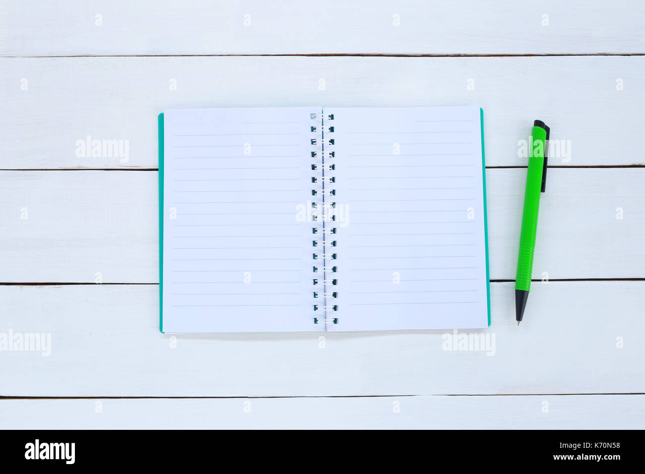 Book and pen on white wood background for design in your work ...
