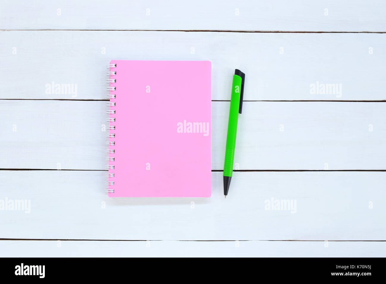 Book and pen on white wood background for design in your work ...