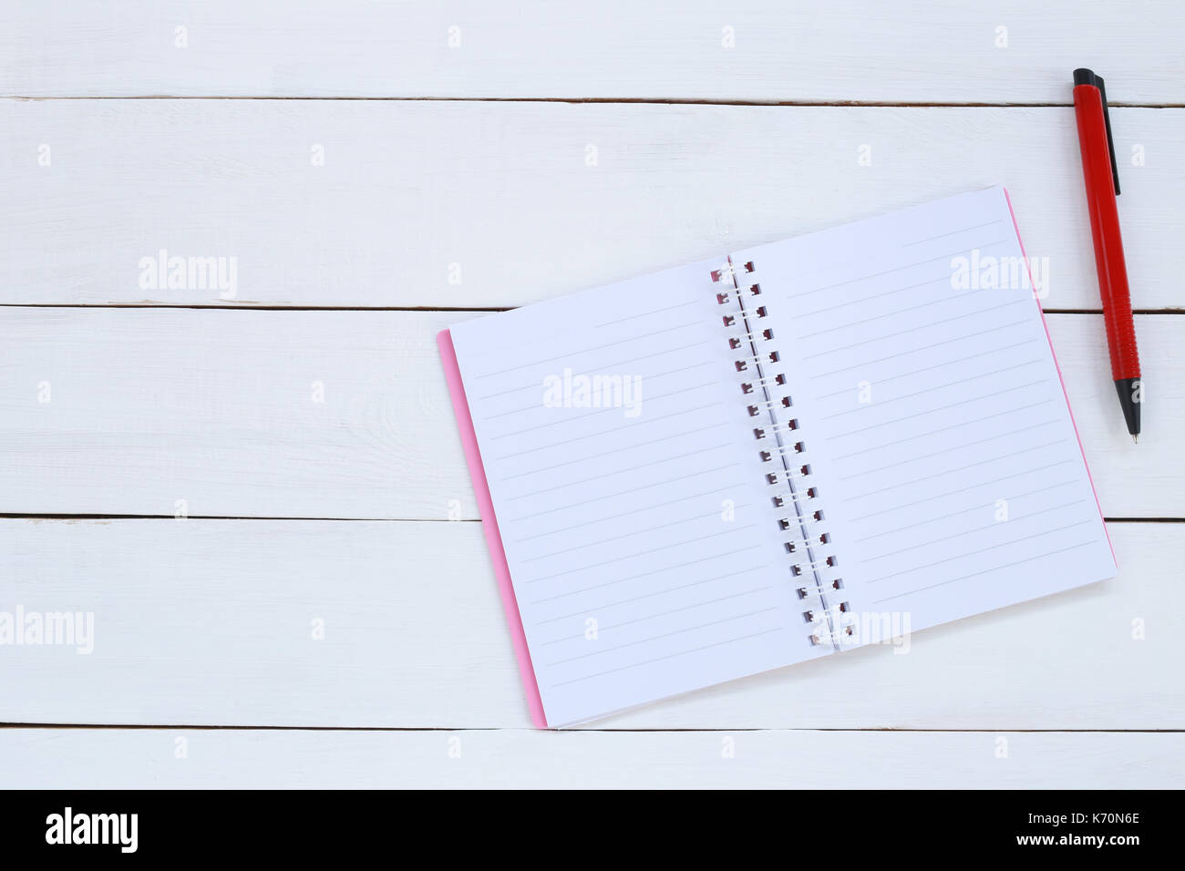 Book and pen on white wood background for design in your work ...