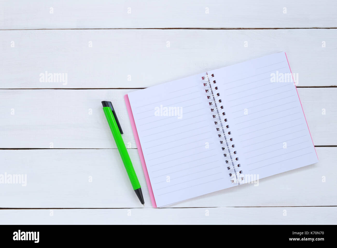 Book and pen on white wood background for design in your work ...