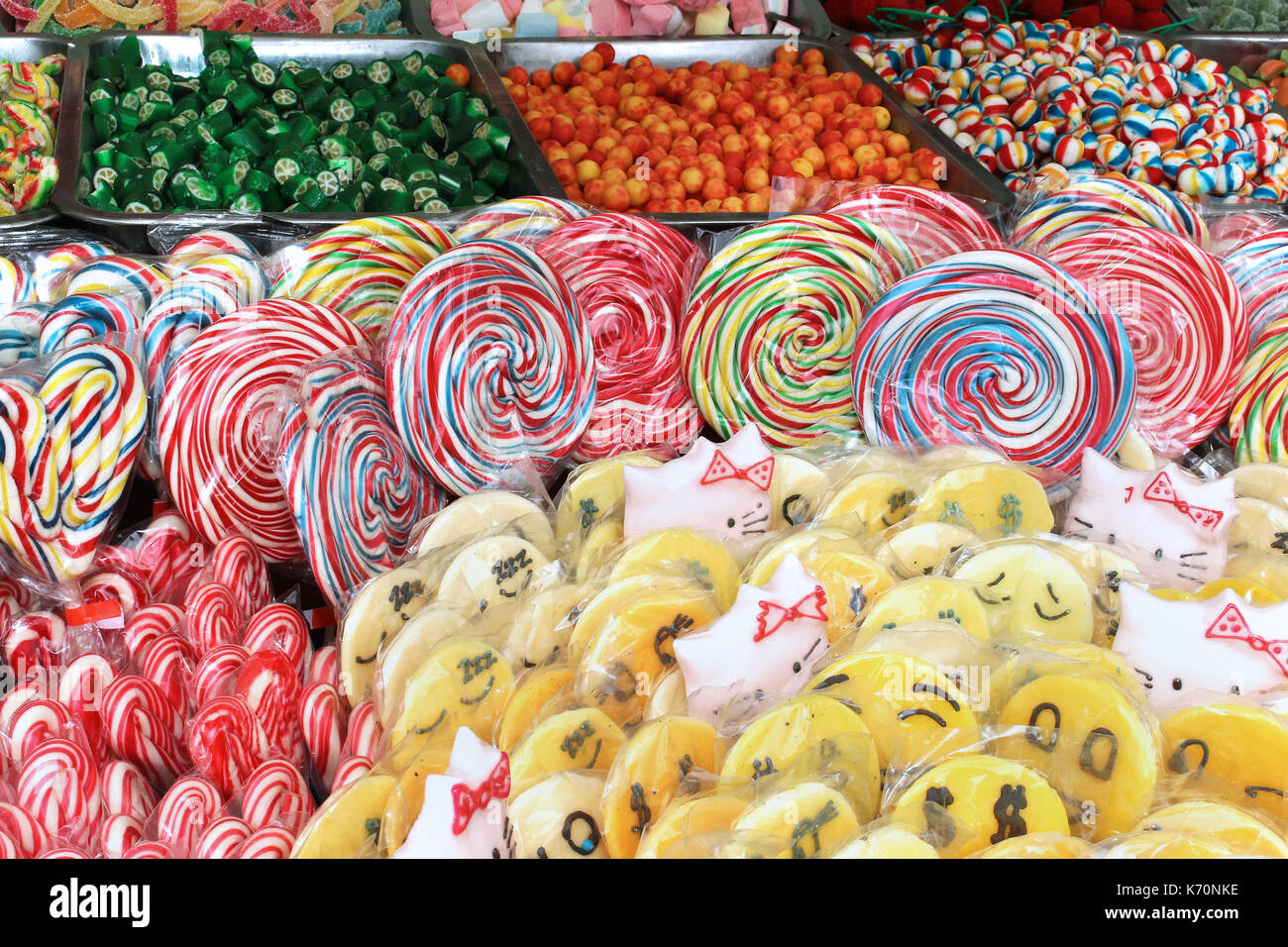 Swirl lollipops and other sweets sold on carnival stand Stock Photo - Alamy