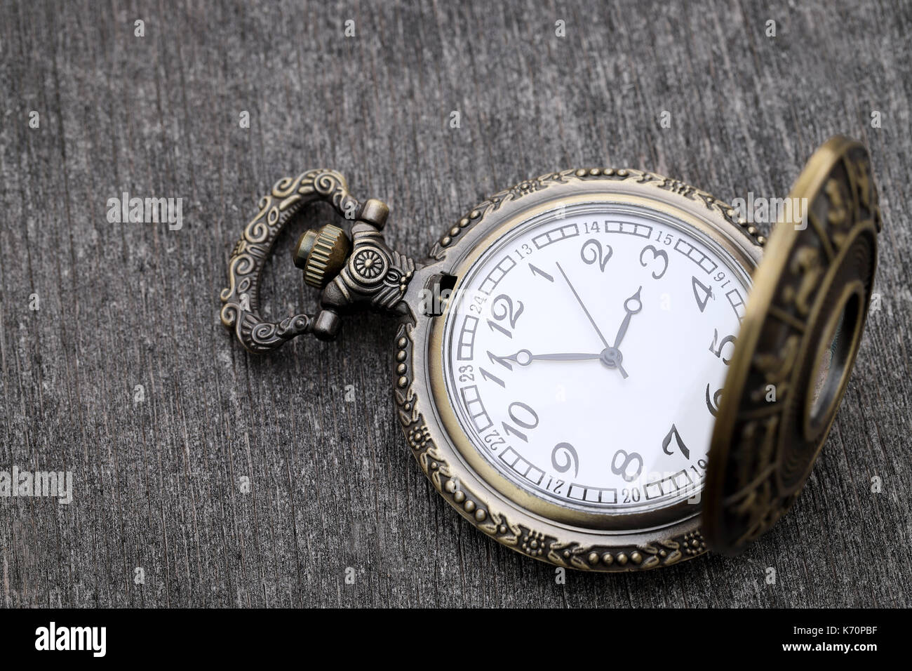 Old pocket watch on dark gray table background Stock Photo - Alamy