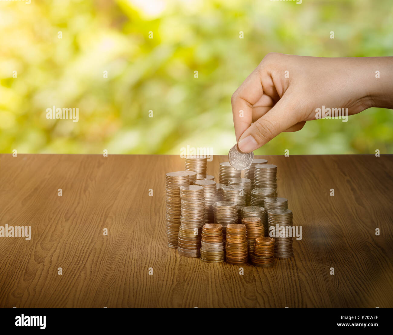 hand putting money coin stack, Saving money concept Stock Photo - Alamy