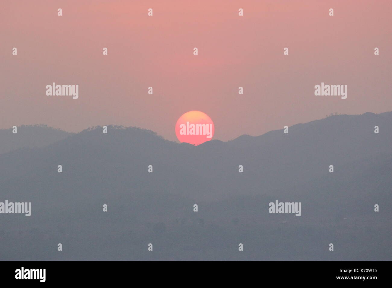 Sunset behind the hill Stock Photo - Alamy
