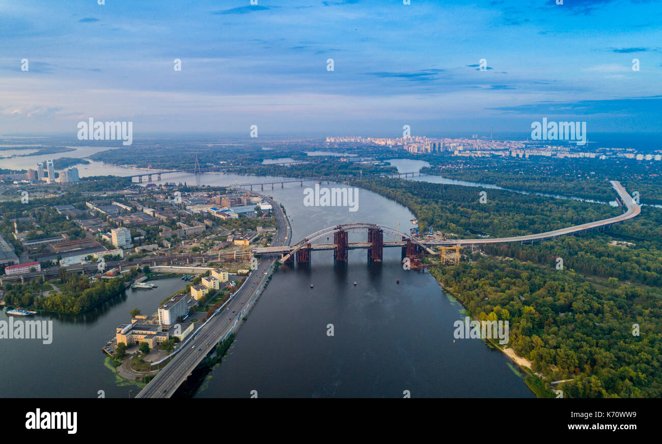 Panoramic view of a modern city with a river, unfinished bridge and ...
