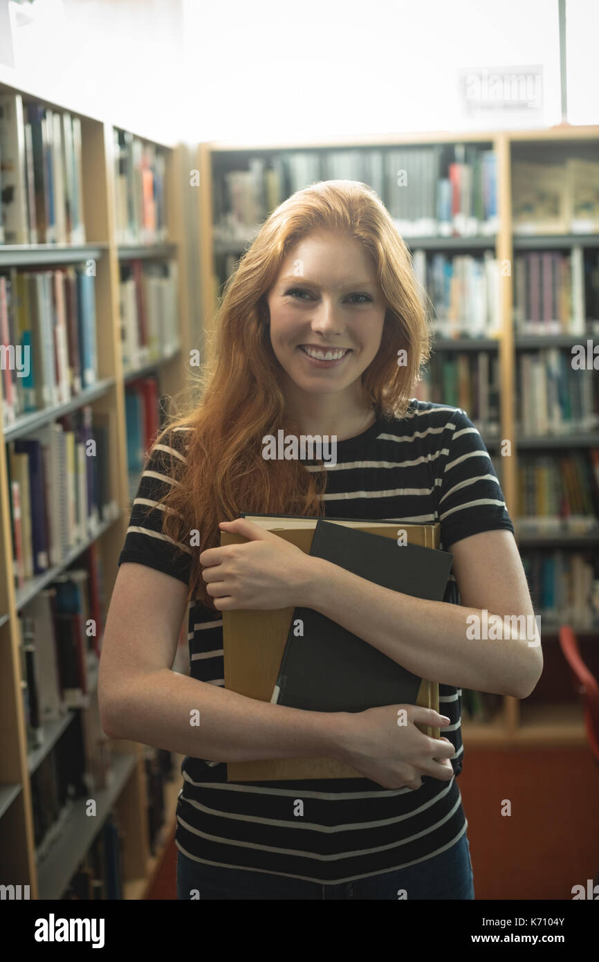 Holding books in library hi-res stock photography and images - Alamy