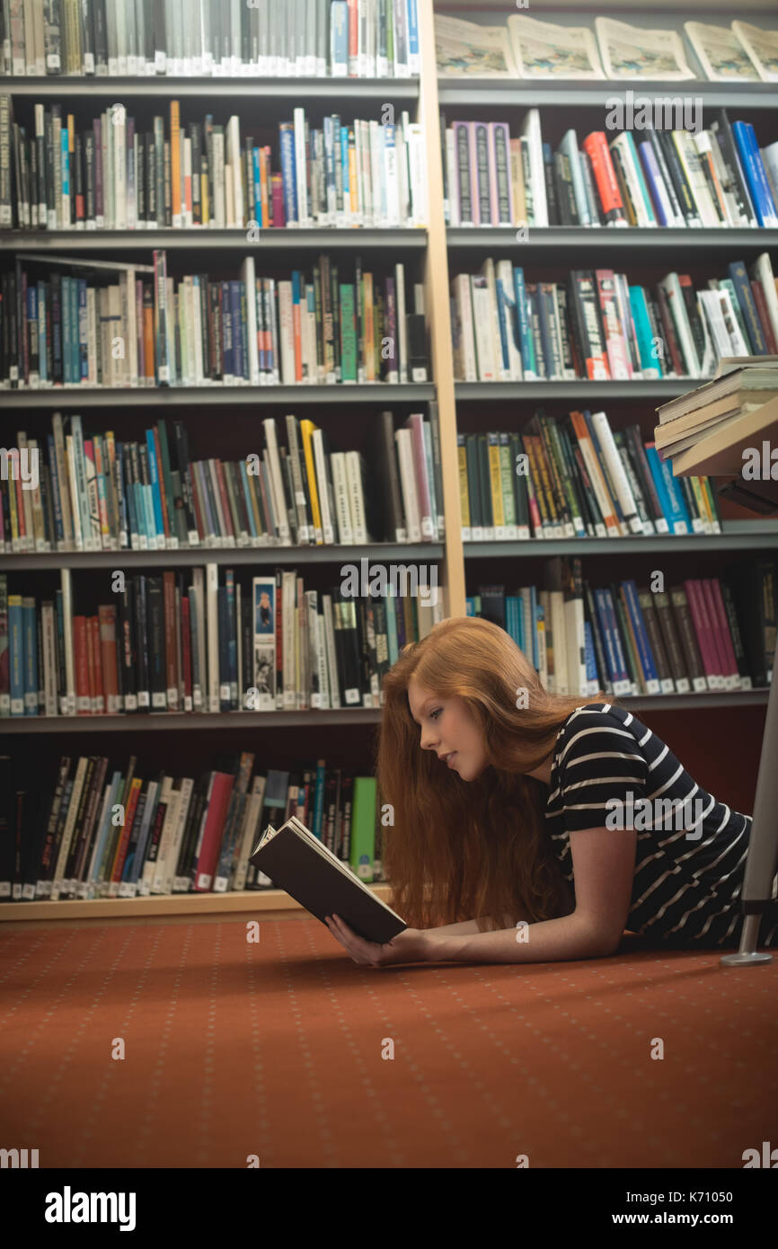 Beautiful woman reading book in library room Stock Photo - Alamy