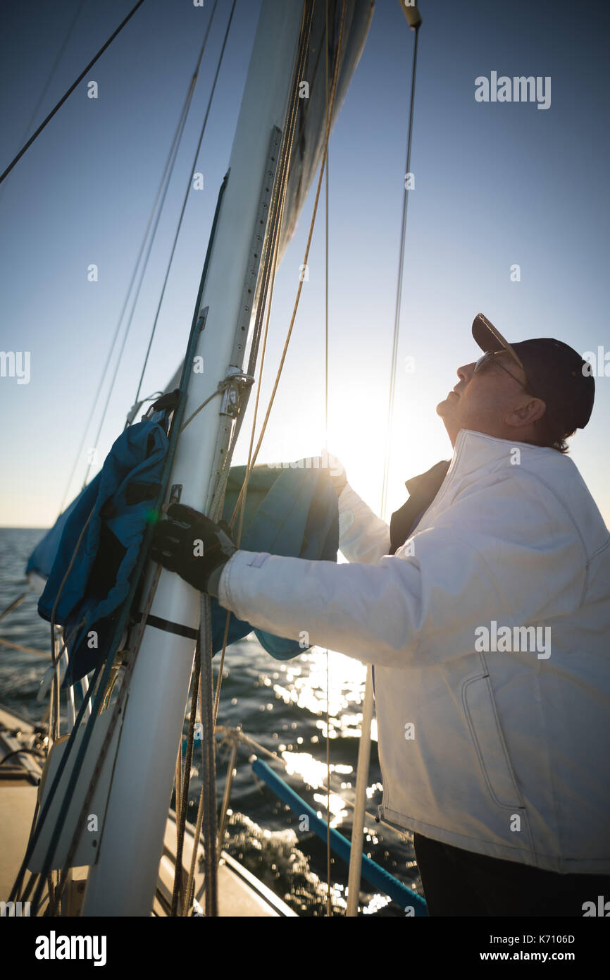 Yachtsman pulling the rope tuning the sails on a sunny day Stock Photo ...
